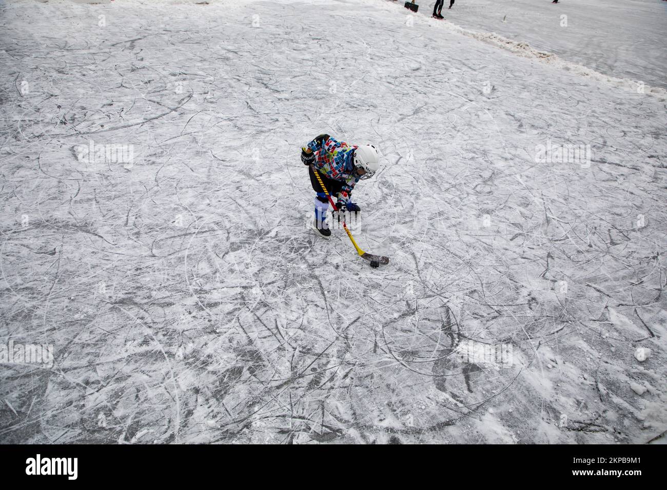 A boy is learning to play ice hockey on the Beishanxi Lake in Jilin ...