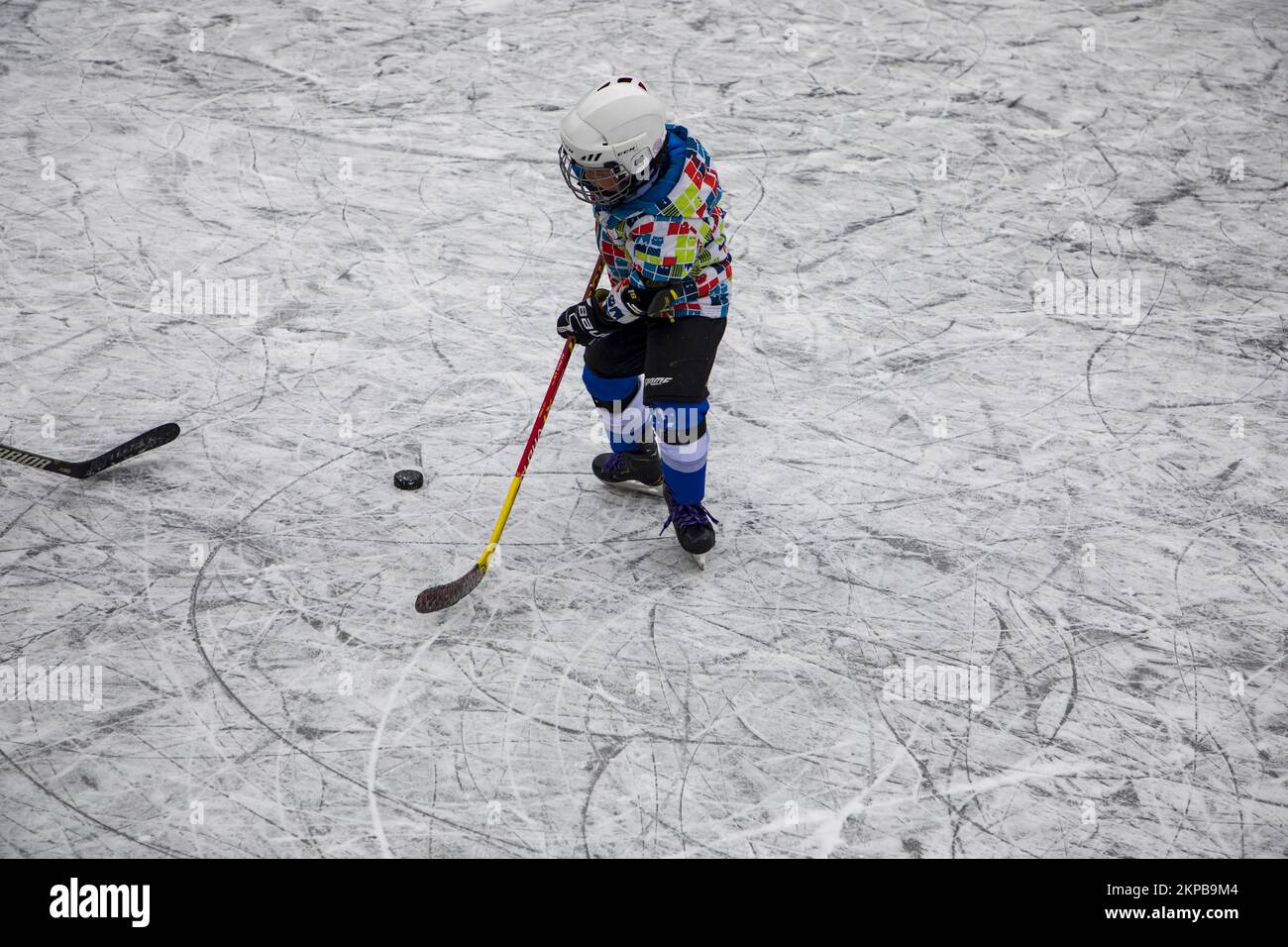 A boy is learning to play ice hockey on the Beishanxi Lake in Jilin ...
