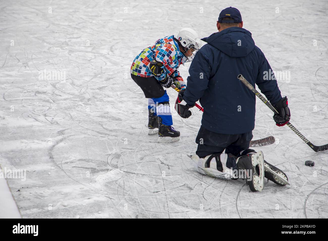 A boy is learning to play ice hockey on the Beishanxi Lake in Jilin ...