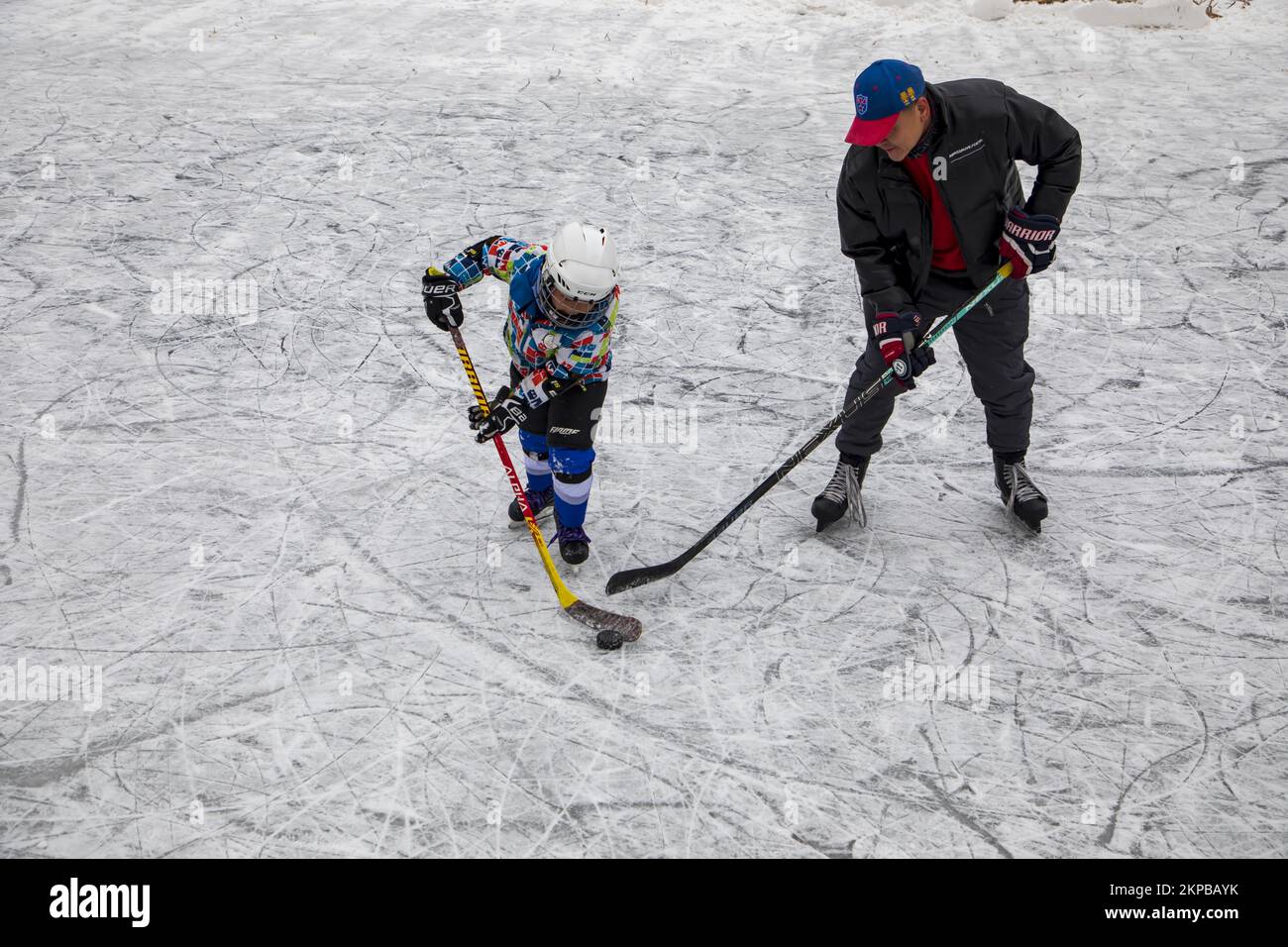 A boy is learning to play ice hockey on the Beishanxi Lake in Jilin ...