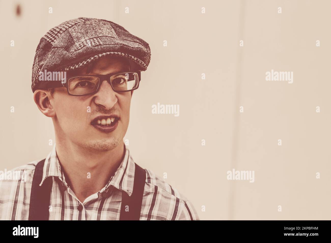 Comical horizontal capture of a vintage man snarling with toothy grunt ...