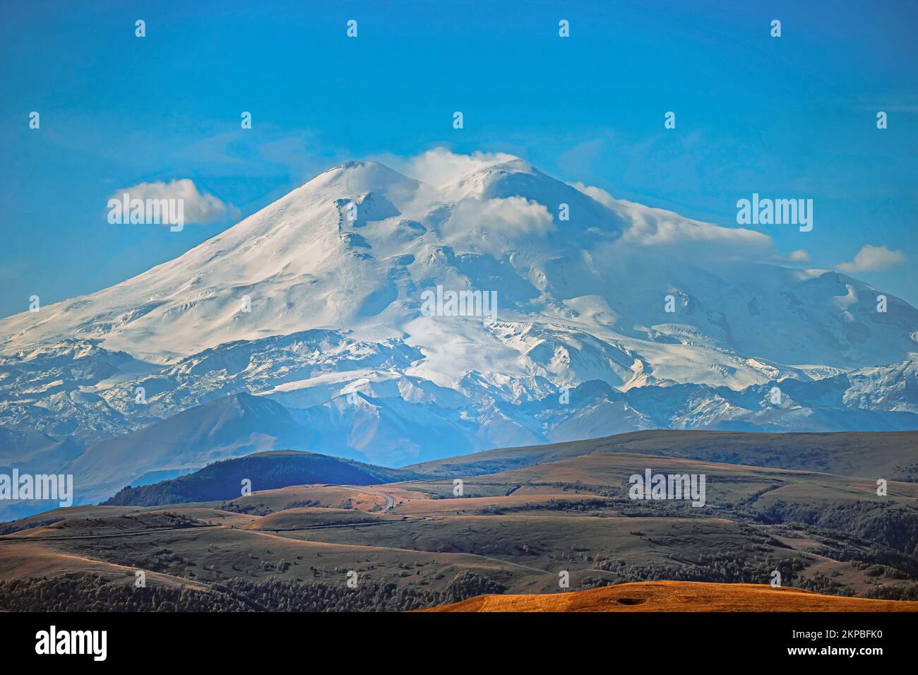 Big mountain Elbrus. Snow covered Greater Caucasus mountains. The two peaks of Mount Elbrus ...