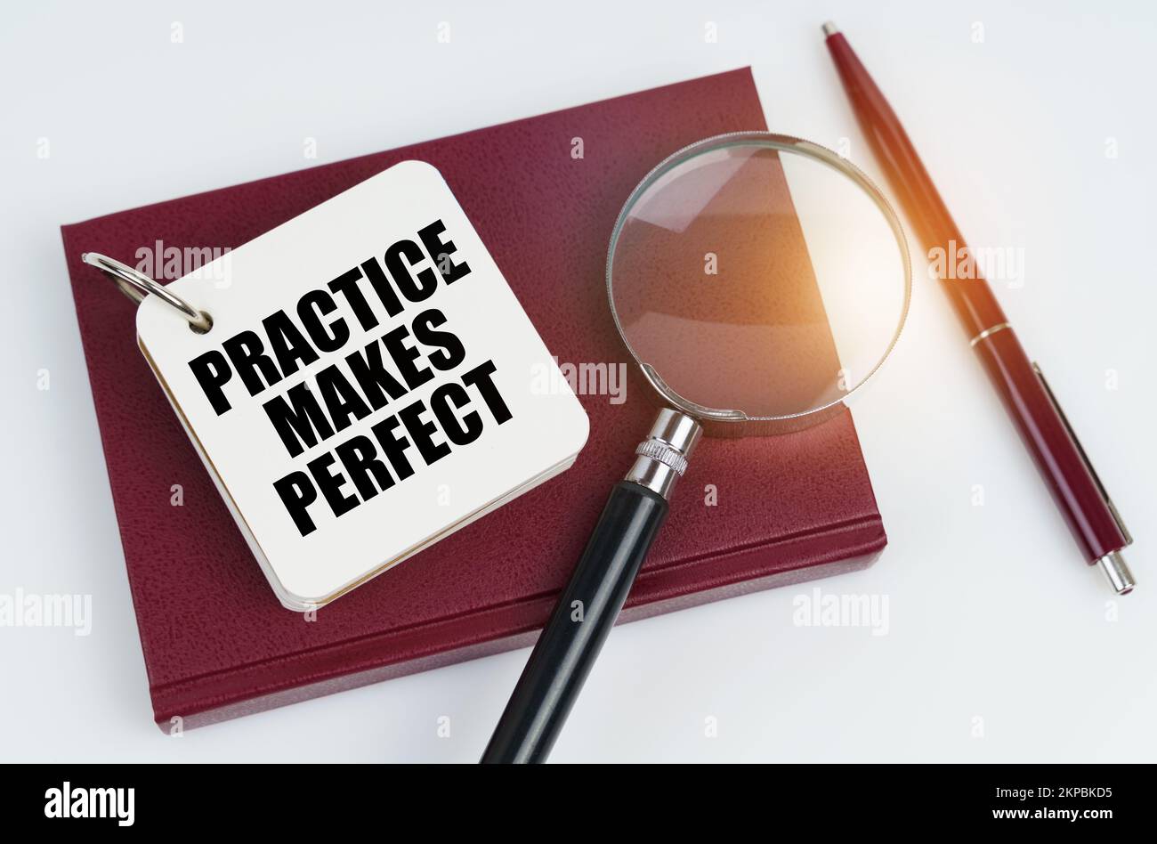 Business and finance concept. On a white surface lies a red notebook ...