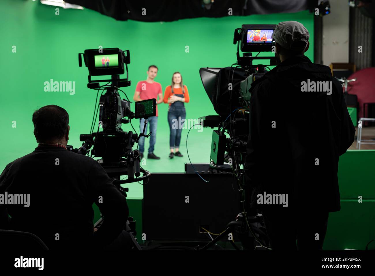 Lights.. Camera.. Action! Woman and Man anchor reporting news in studio ...