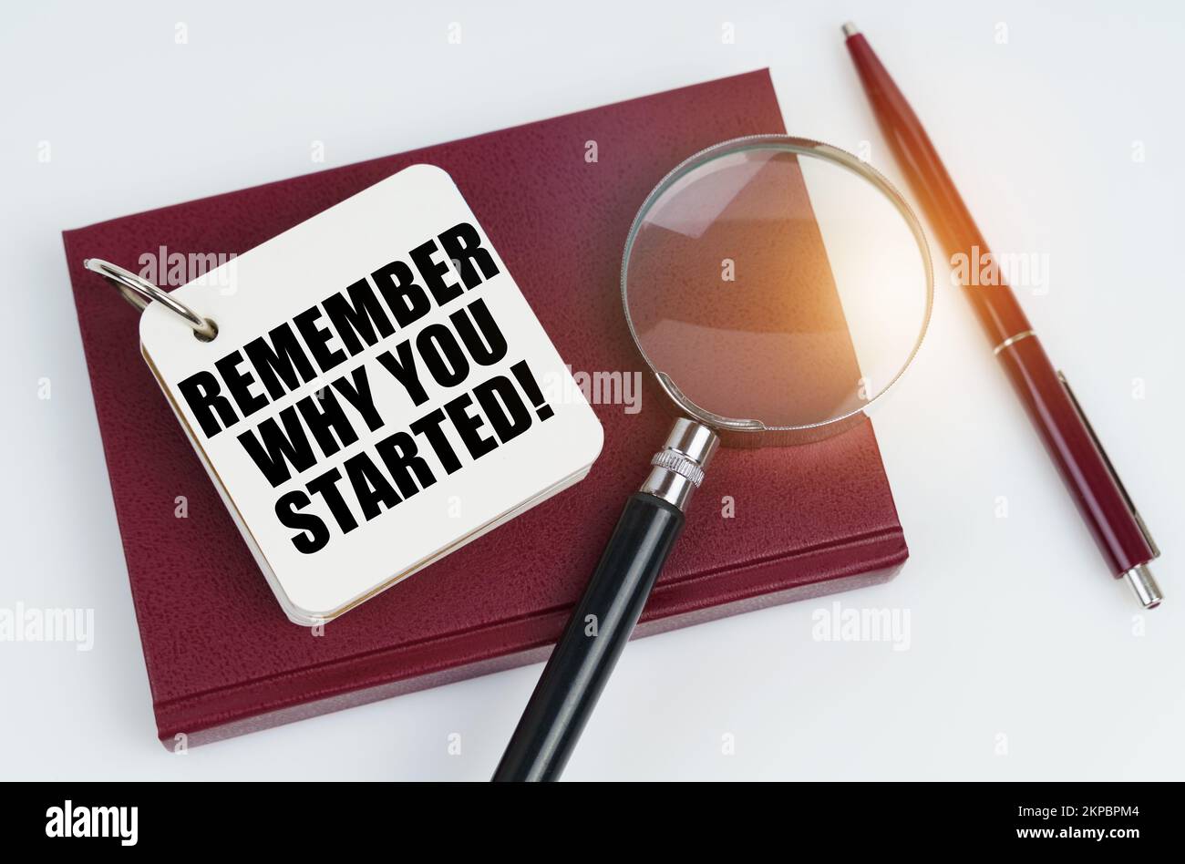 Business and finance concept. On a white surface lies a red notebook ...