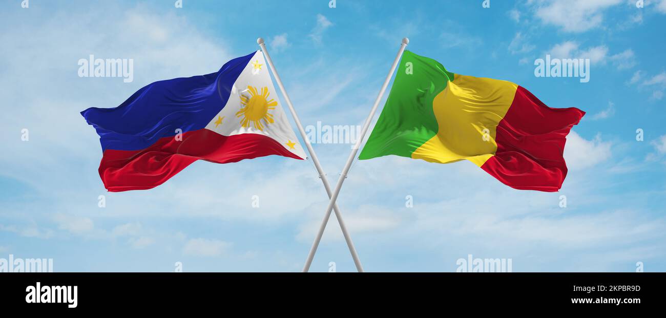 two crossed flags Mali and Philippines waving in wind at cloudy sky ...