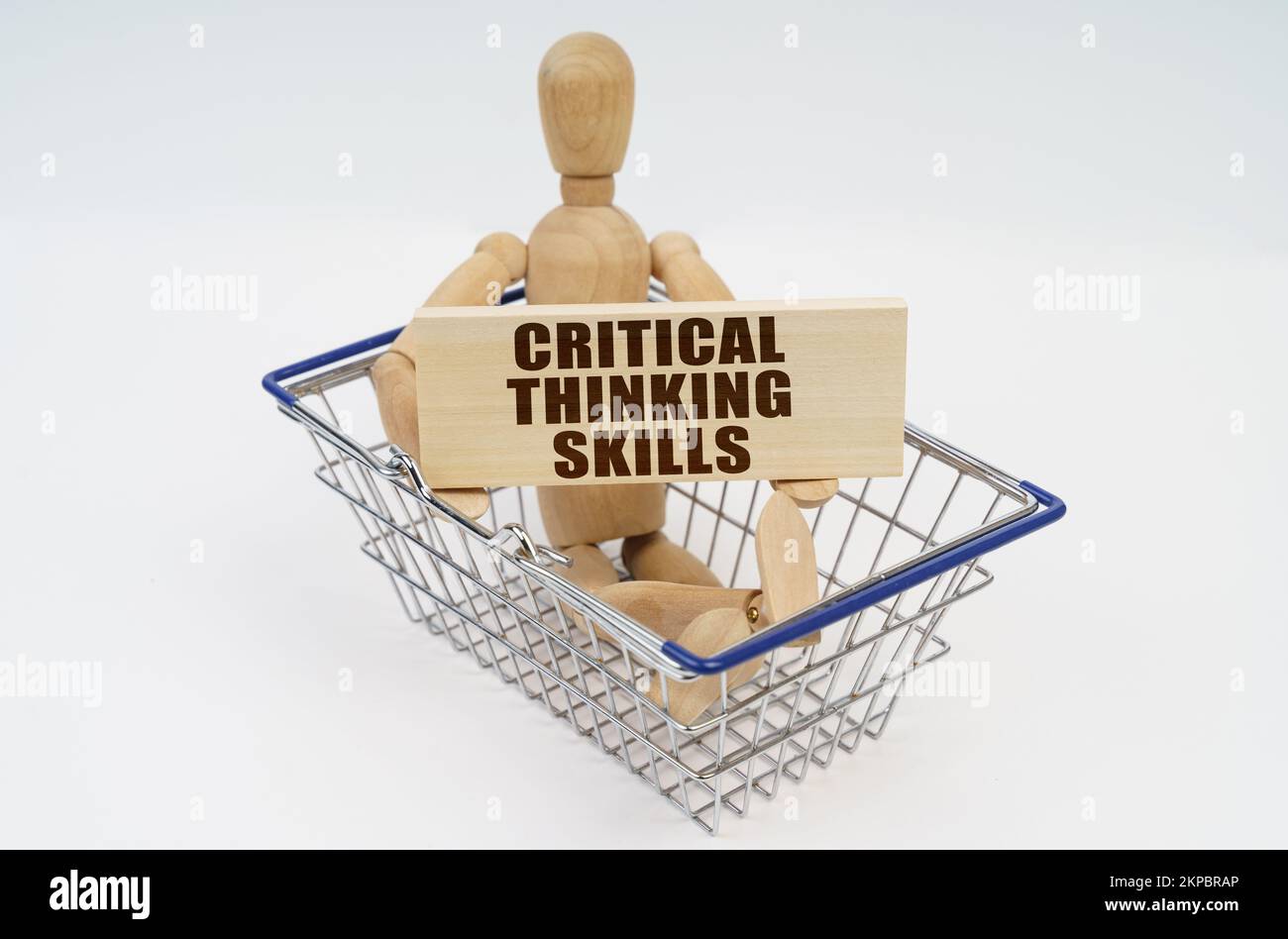 Business and finance concept. A wooden man sits in a shopping basket ...