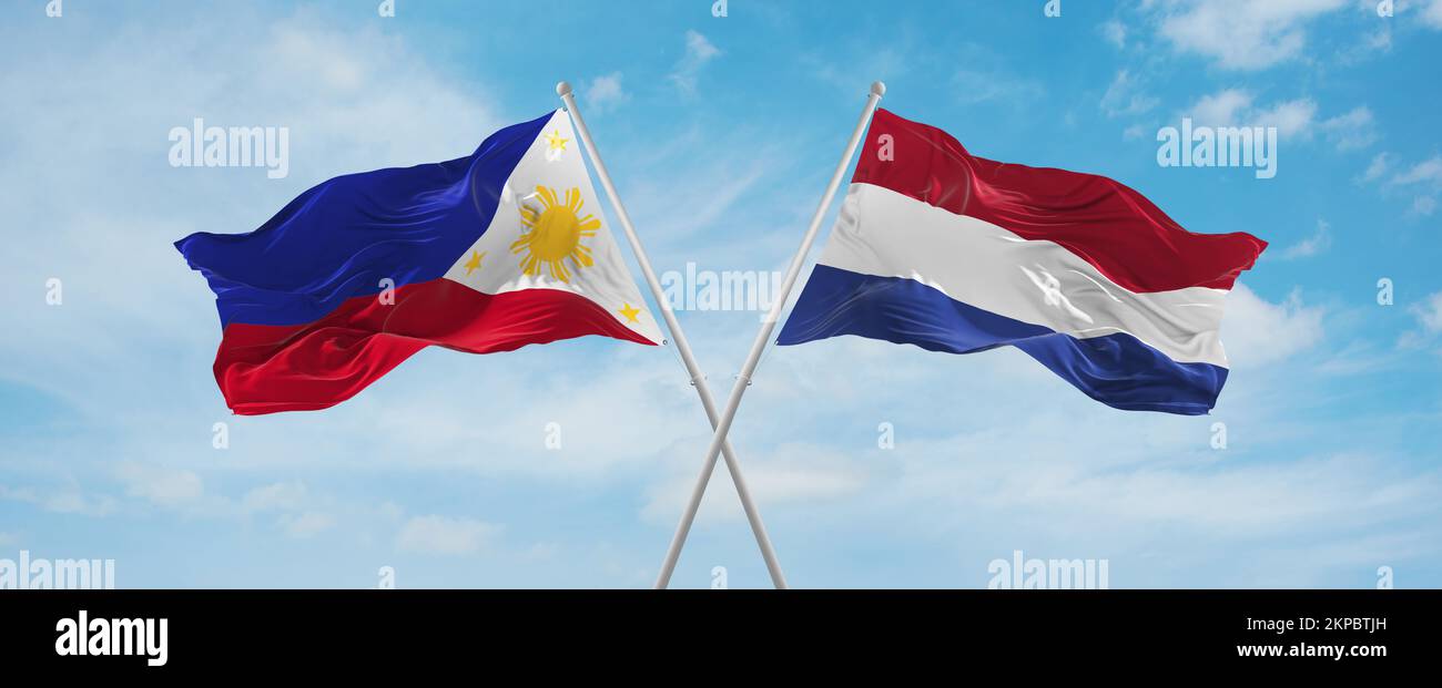 two crossed flags netherlands and Philippines waving in wind at cloudy ...