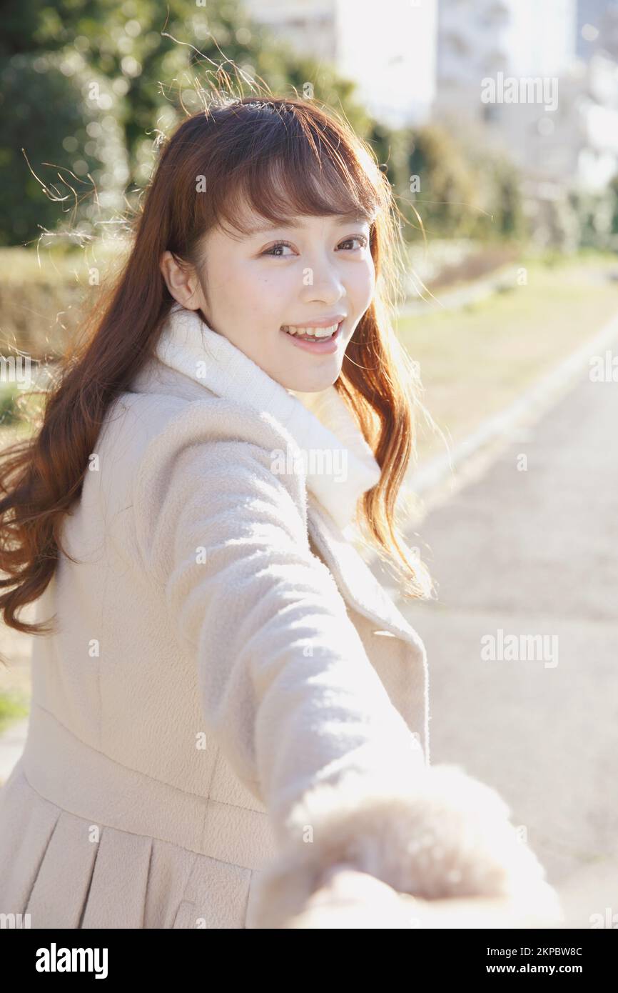 Japanese woman looking back with a smile Stock Photo - Alamy