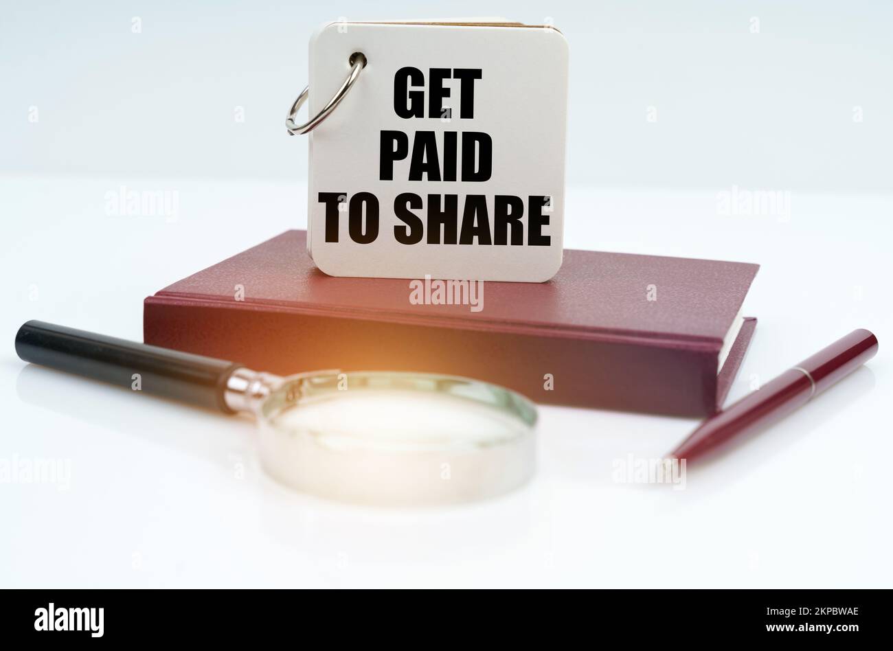 Business and finance concept. On a white surface lies a red notebook ...