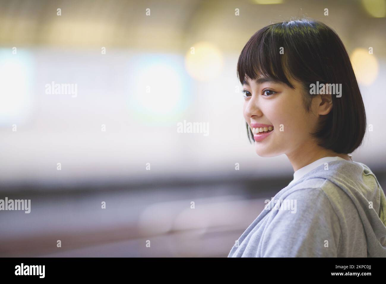 Young Japanese woman on a train platform Stock Photo - Alamy