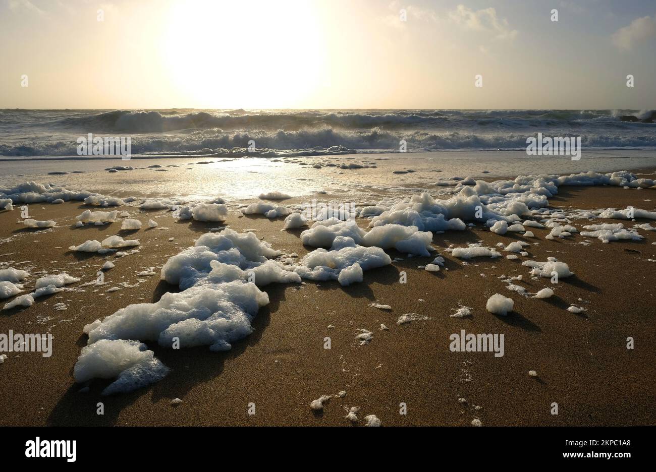 Spume or sea foam forming after a storm, Gunwalloe, Cornwall, UK - John ...