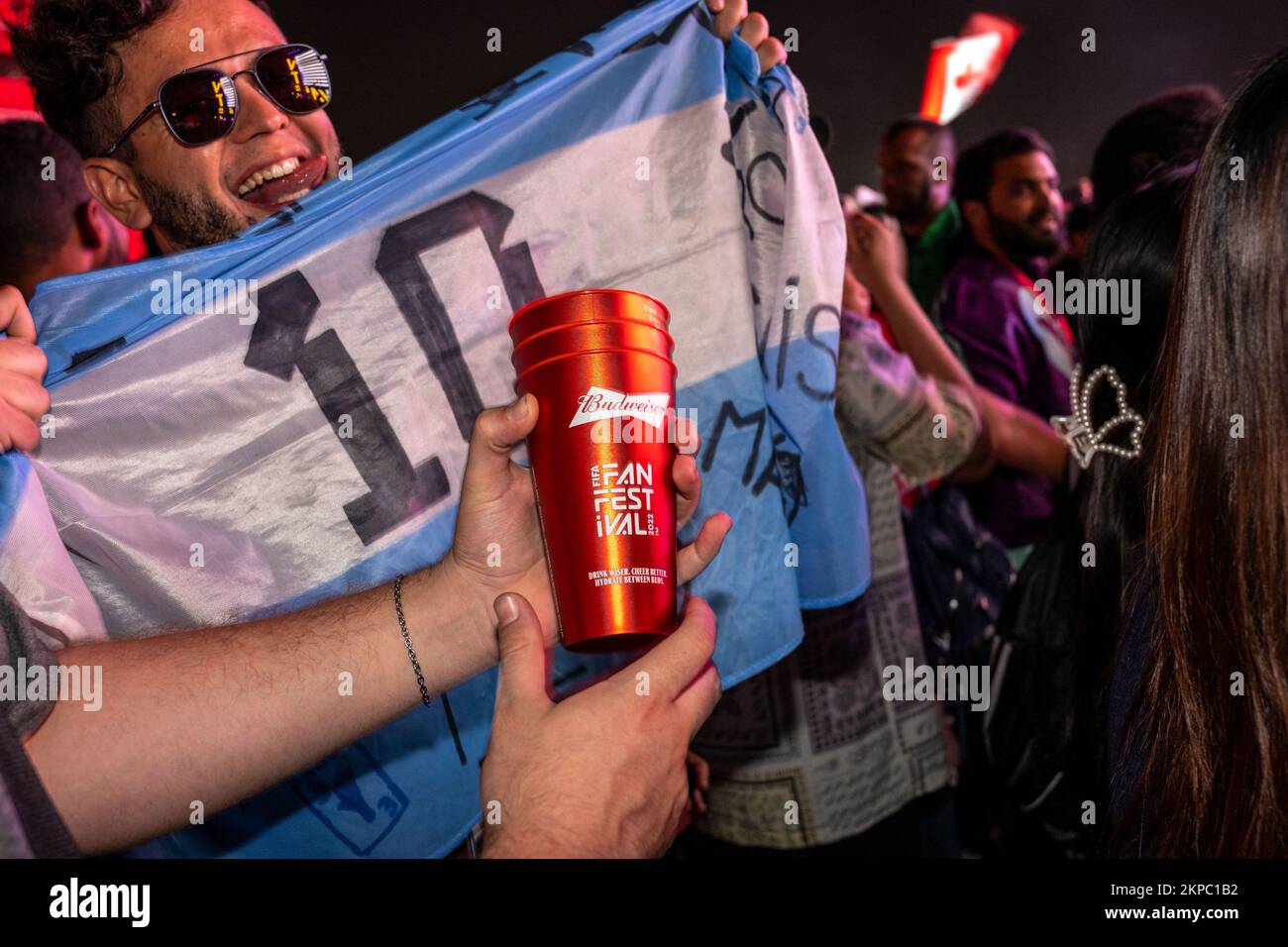 Fans of different teams celebrate and dance together, drinking ...