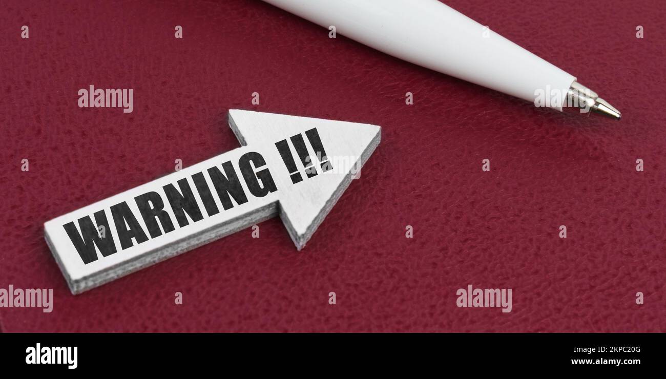 Business and finance concept. On a red background lies a white pen and ...