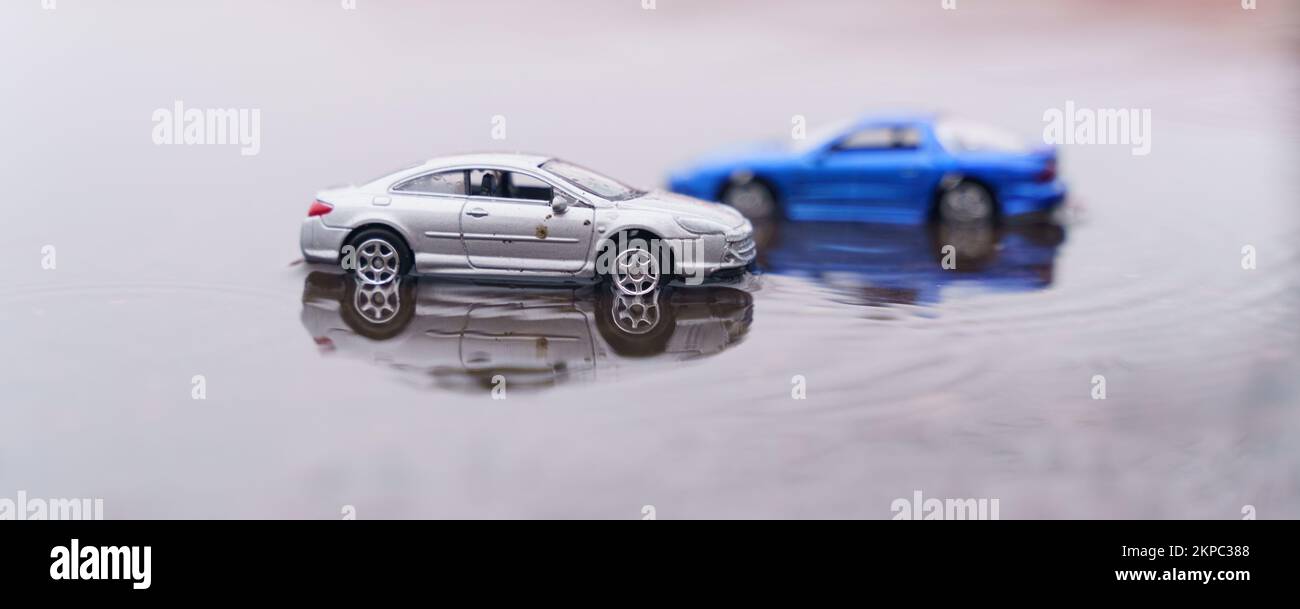 Natural disasters. Two cars are moving along the road after a heavy ...