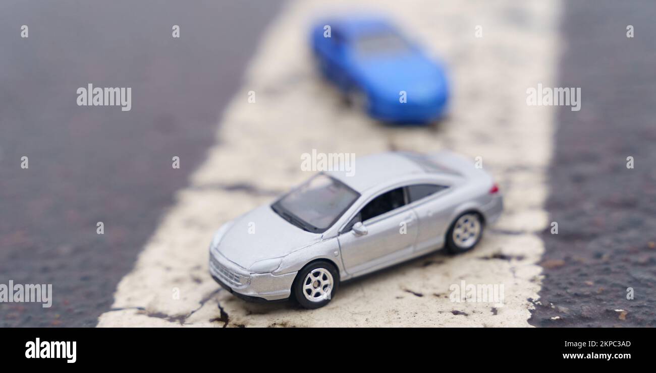 Incidents. Two cars are moving along a solid road marking line. One of ...