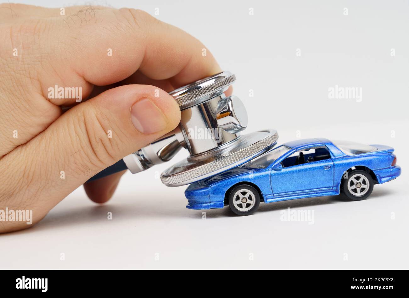 Automotive diagnostics. A stethoscope lies on the roof of a toy car ...