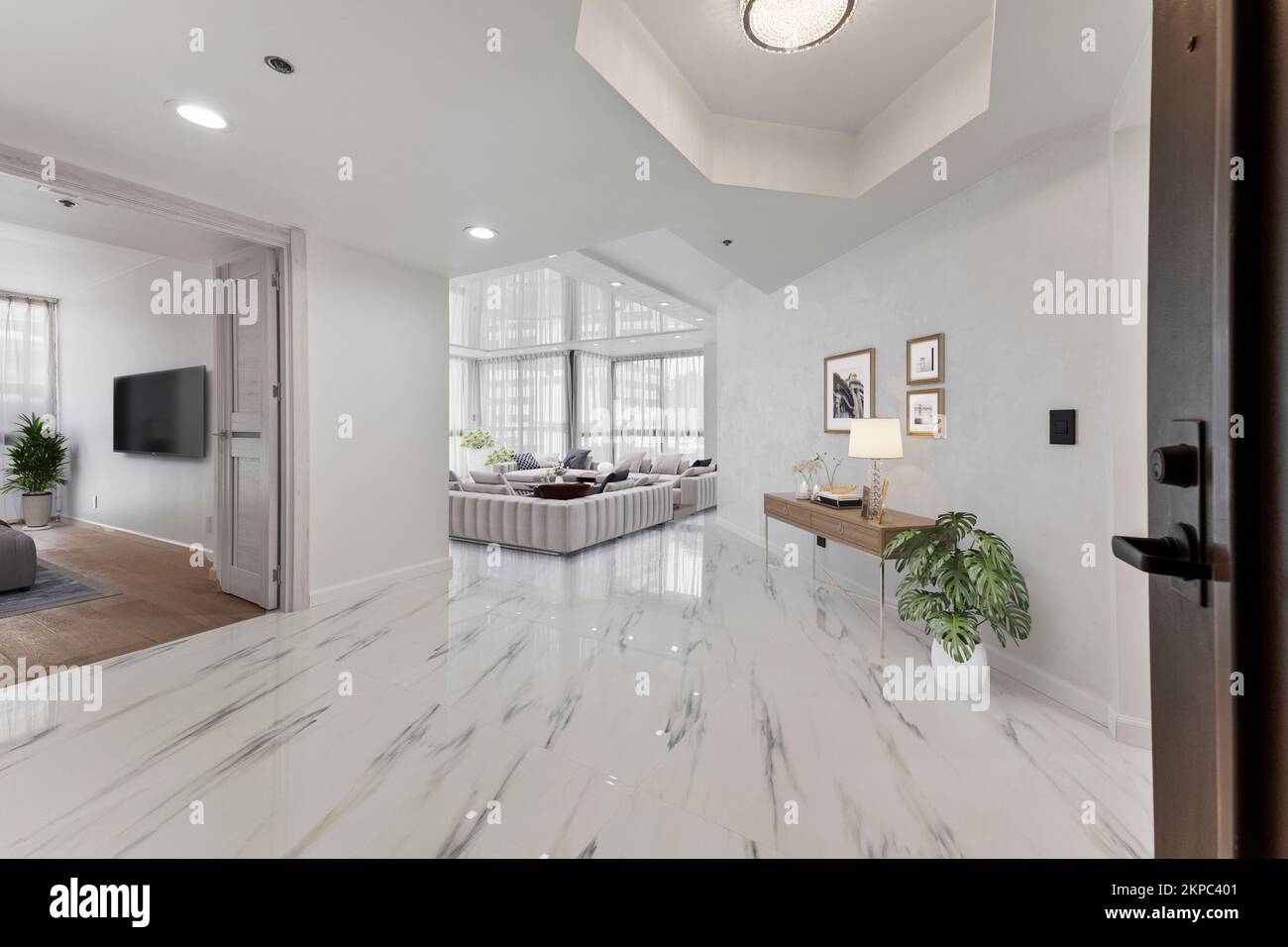 A modern large corridor with marble tiles leading to a living room and ...