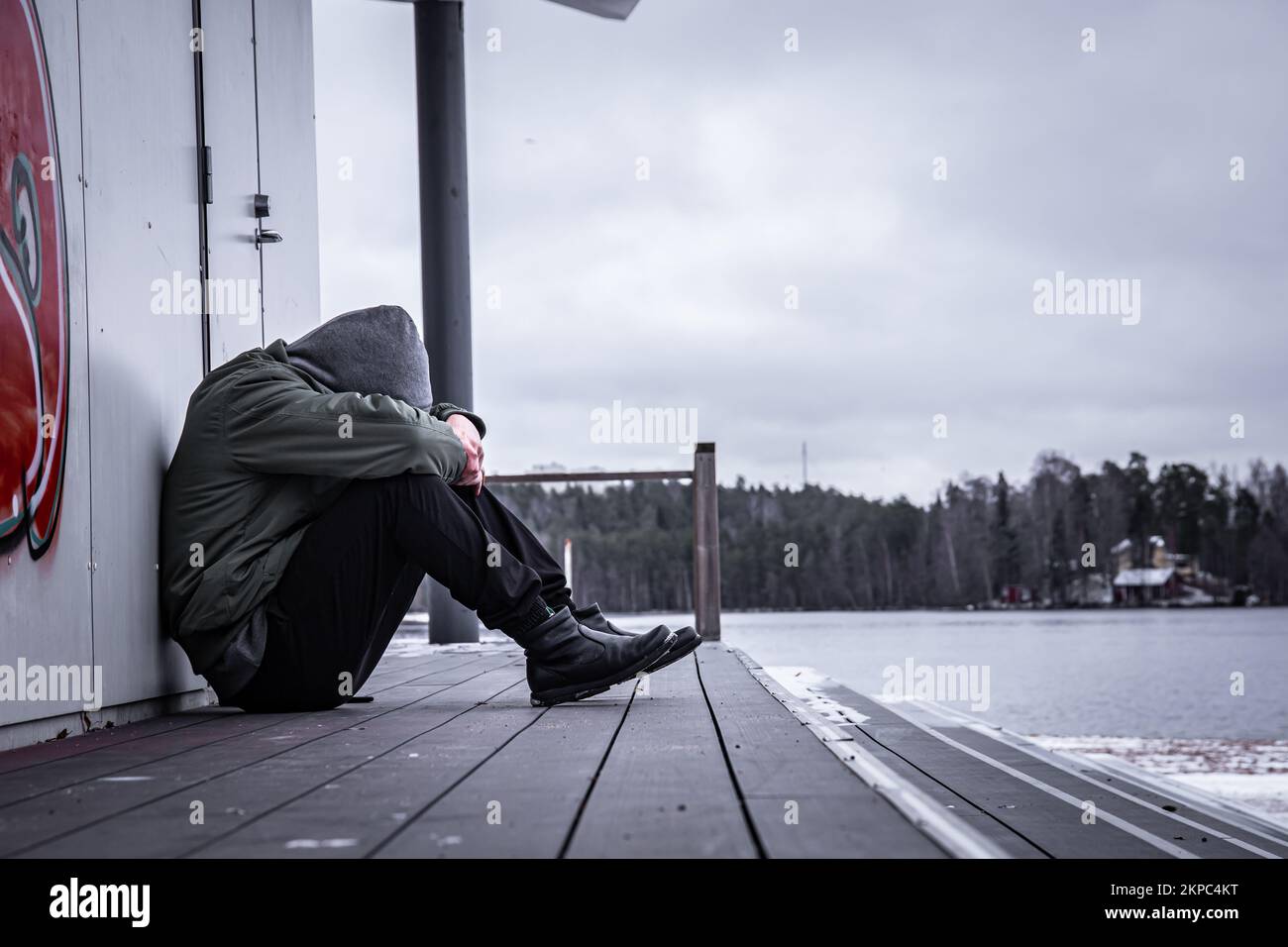 A lonely and sad man sitting on the ground Stock Photo - Alamy