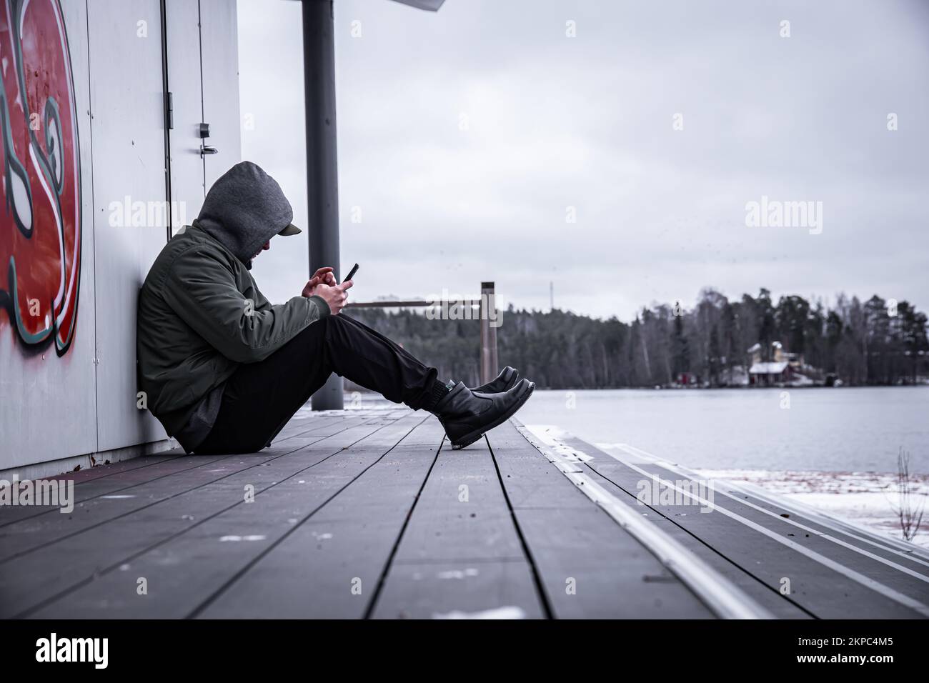 A lonely and sad man sitting on the ground Stock Photo - Alamy