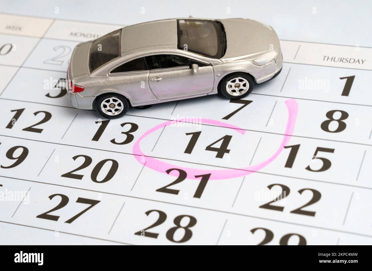 Planning. There is a toy car on the calendar with the date stamped. A ...