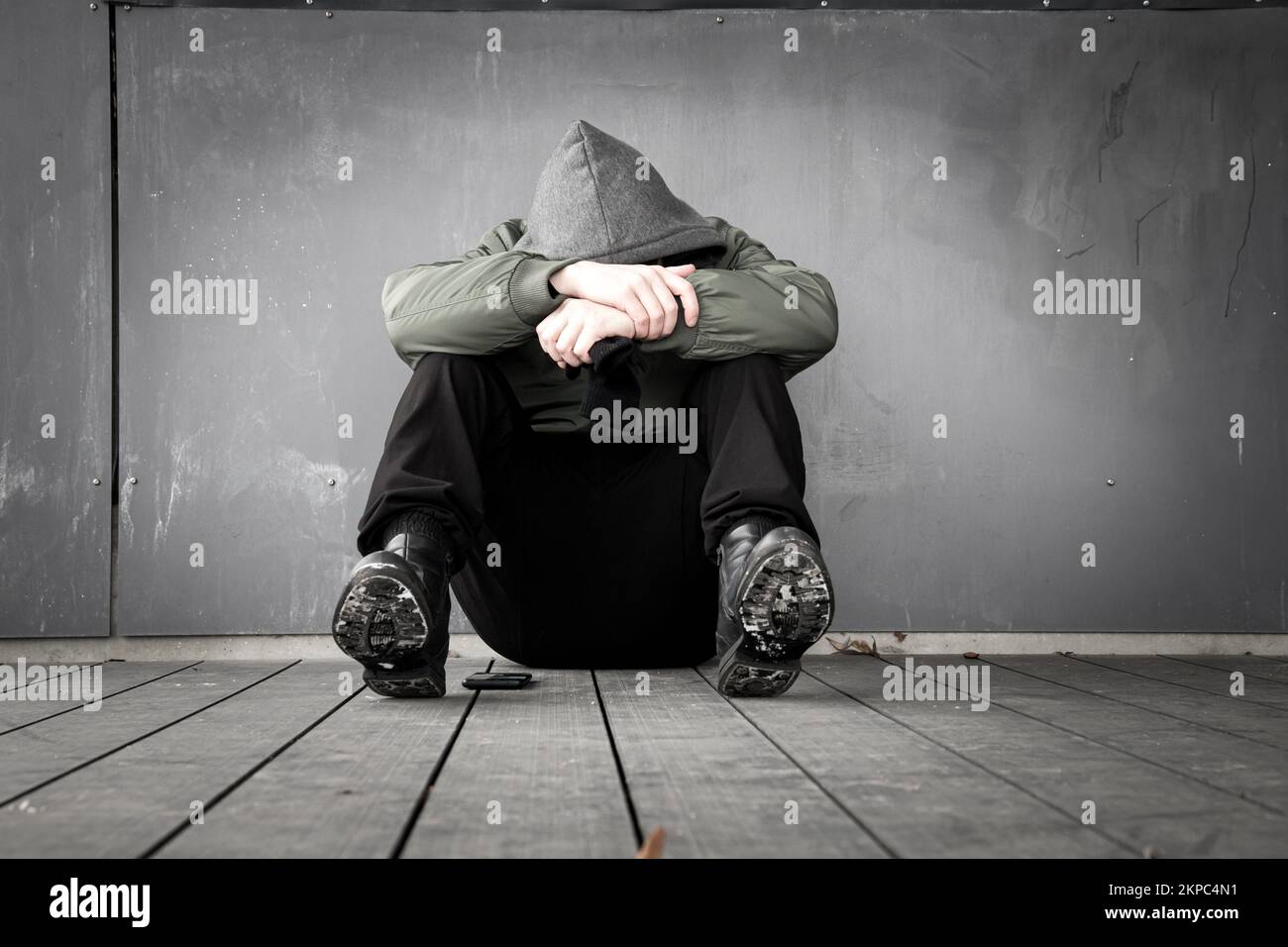 A lonely and sad man sitting on the ground Stock Photo - Alamy