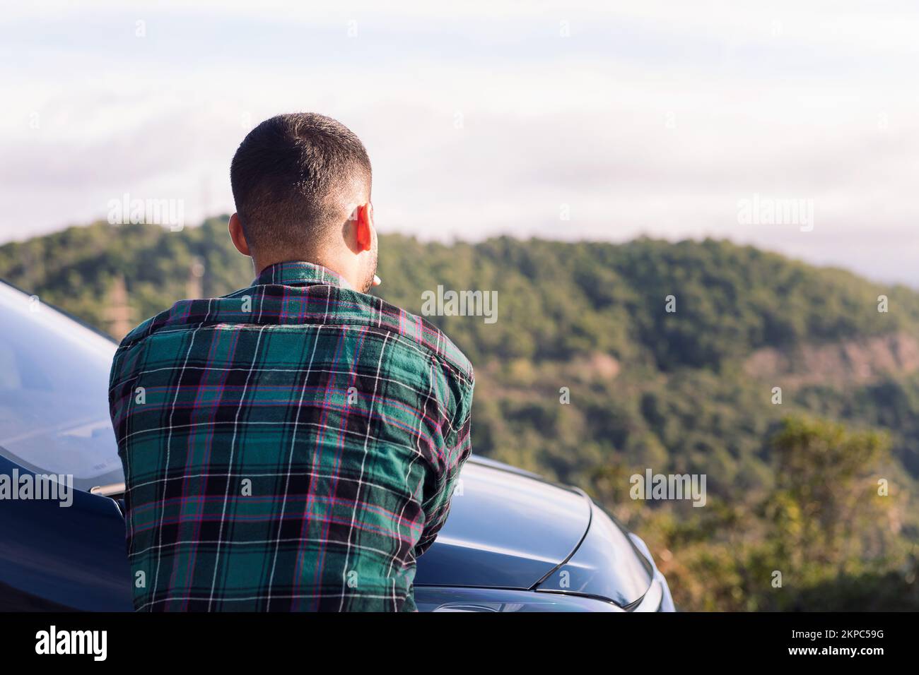 man leaning on his camper van observing nature Stock Photo - Alamy