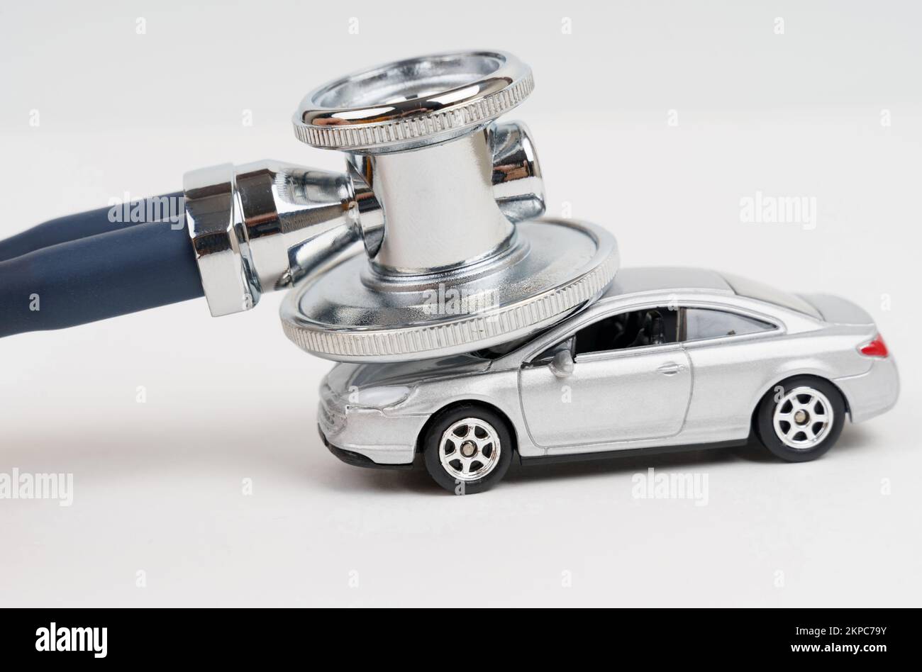 Automotive diagnostics. A stethoscope lies on the roof of a toy car ...