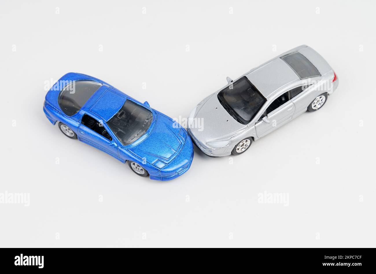 Occurrence. Collision of silver and blue toy cars. Isolated on white ...