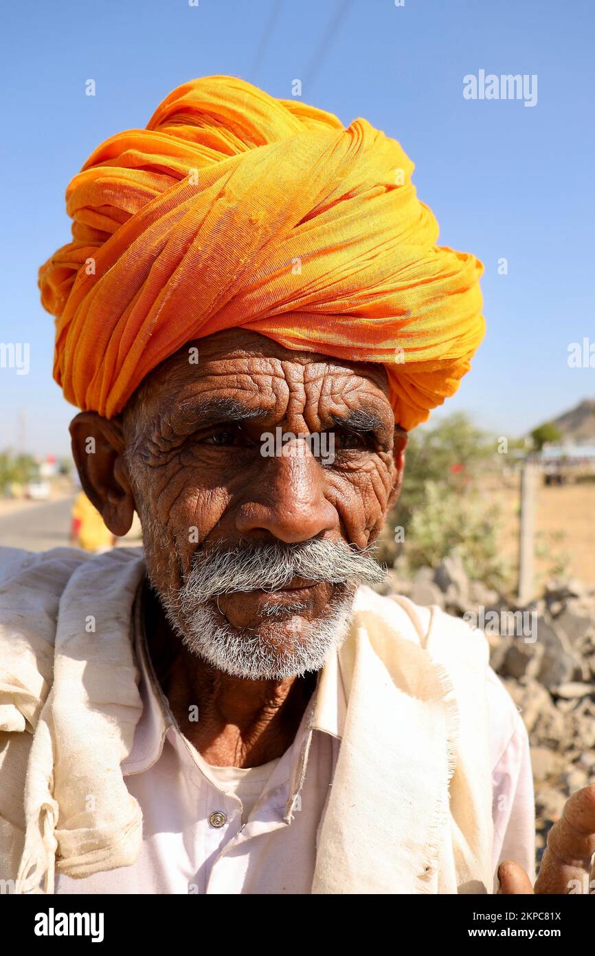 A headshot portrait of a Rajasthani or Marwadi old man in the regional ...