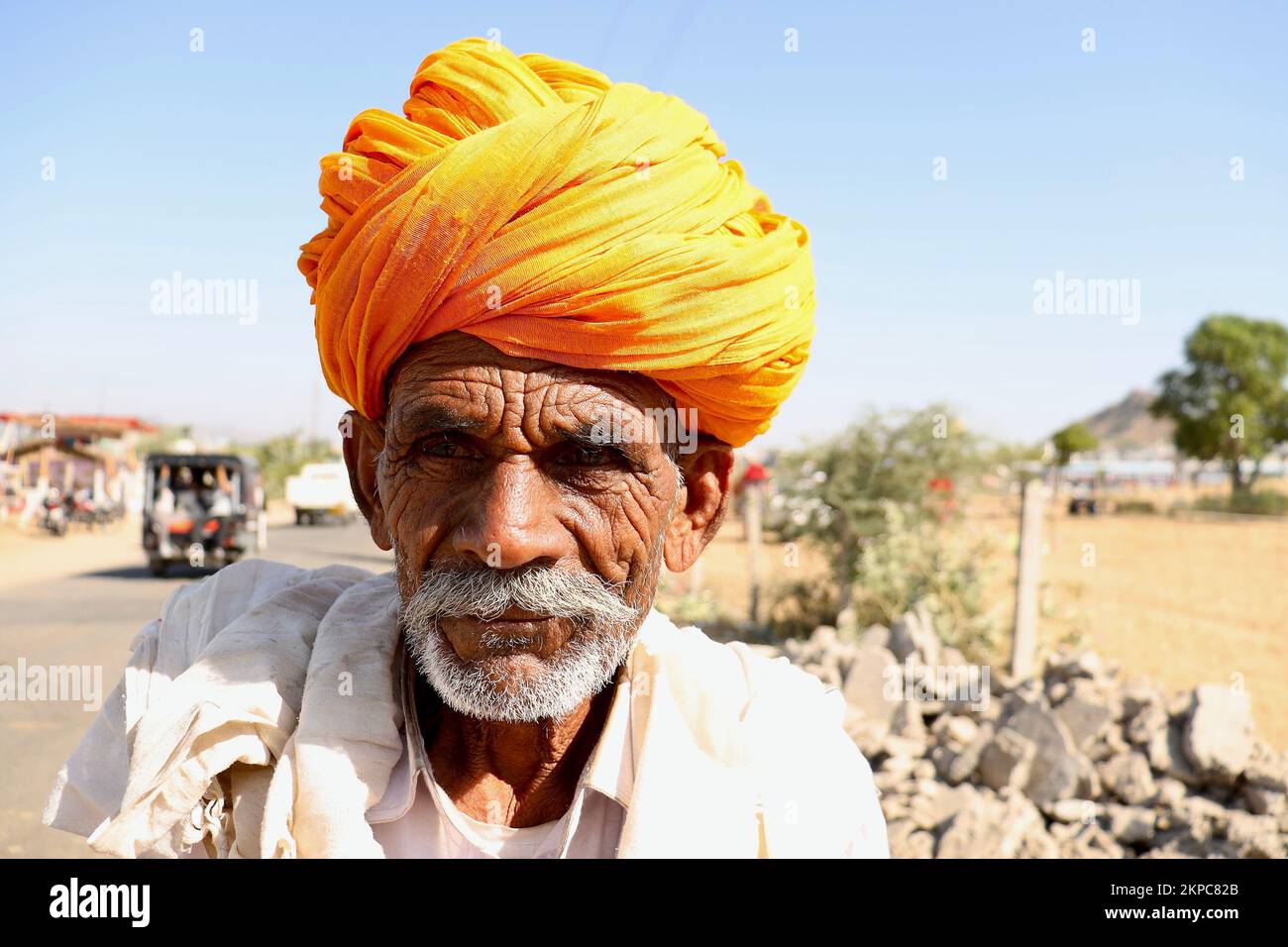 A headshot portrait of a Rajasthani or Marwadi old man in the regional ...