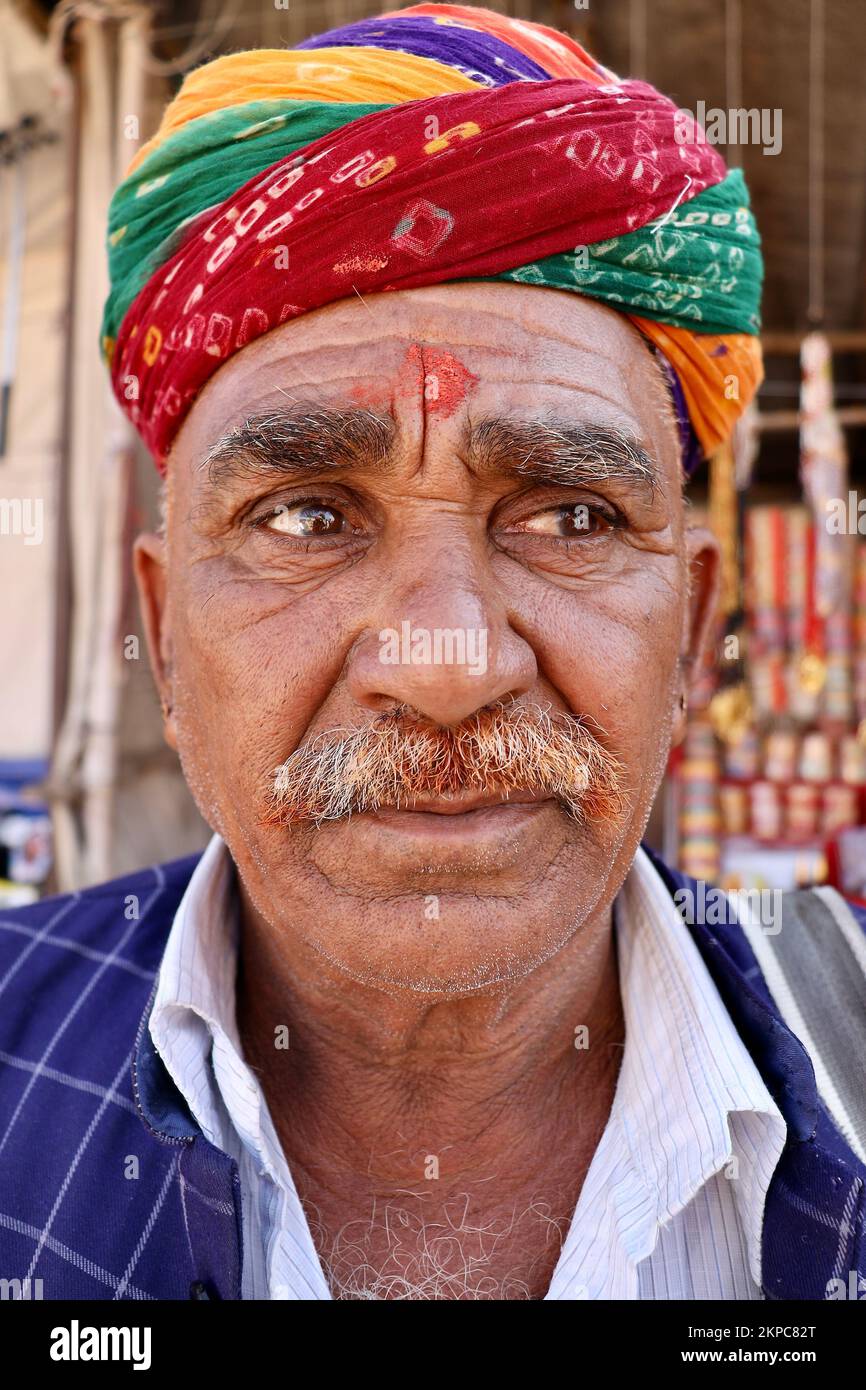 A headshot portrait of a Rajasthani or Marwadi old man in the regional ...