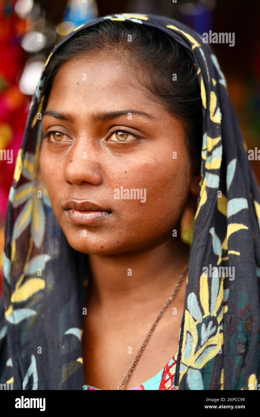 A vertical portrait of an Indian Kalbelia tribal young girl with green ...