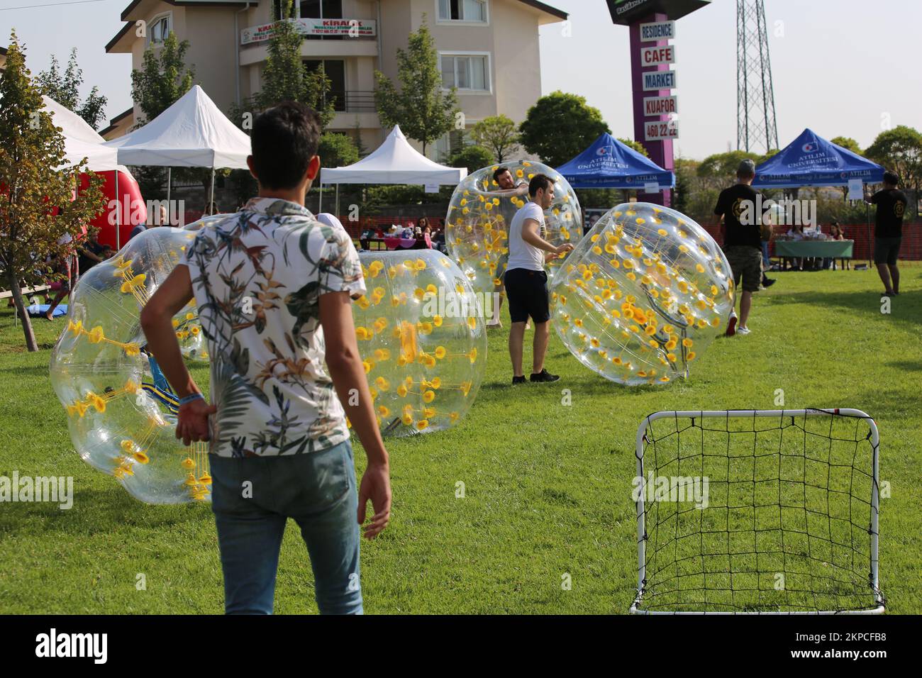 People playing bubble football at the festival area Stock Photo - Alamy