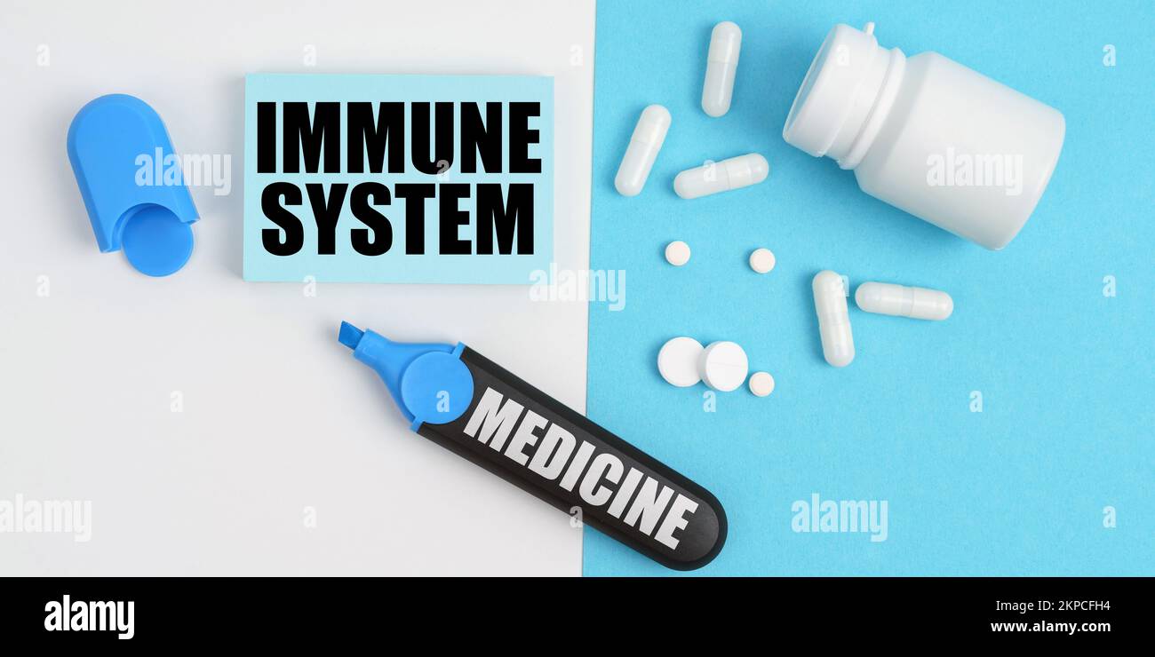 Medical concept. On the white and blue surface are pills, a marker and ...