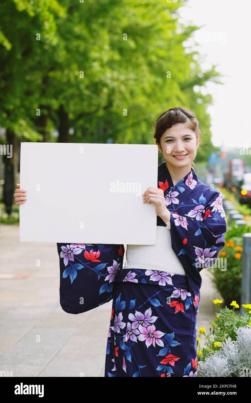 Japanese woman in a yukata holding a whiteboard Stock Photo - Alamy