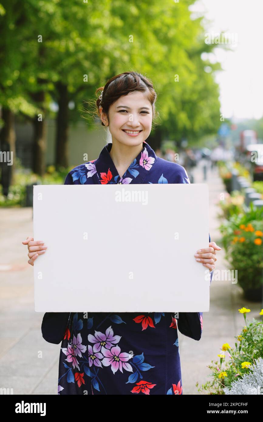 Japanese woman in a yukata holding a whiteboard Stock Photo - Alamy