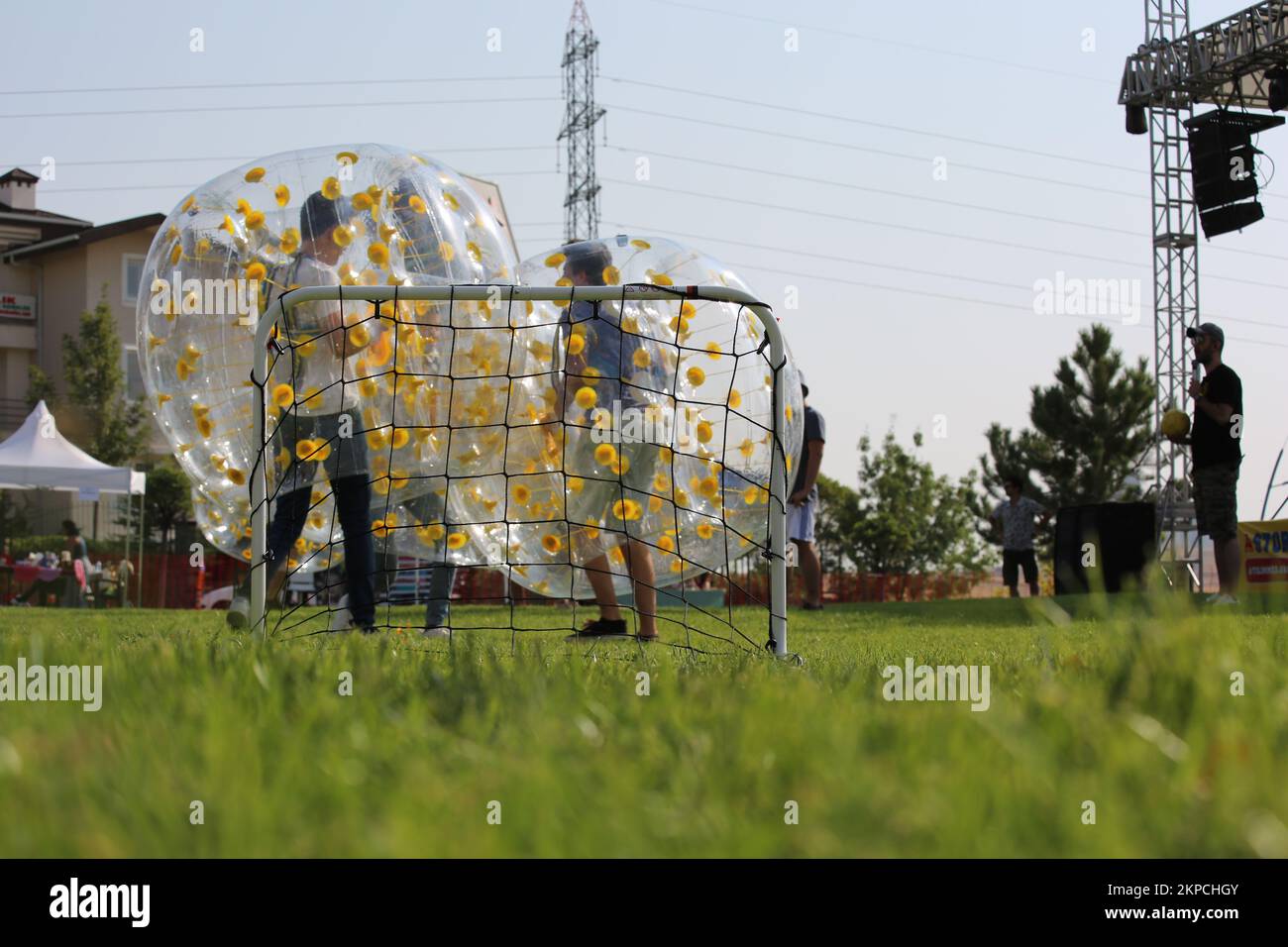 People playing bubble football at the festival area Stock Photo - Alamy