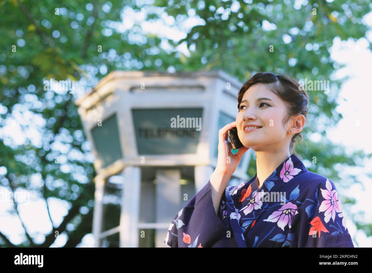 Japanese woman in a yukata making a phone call Stock Photo - Alamy
