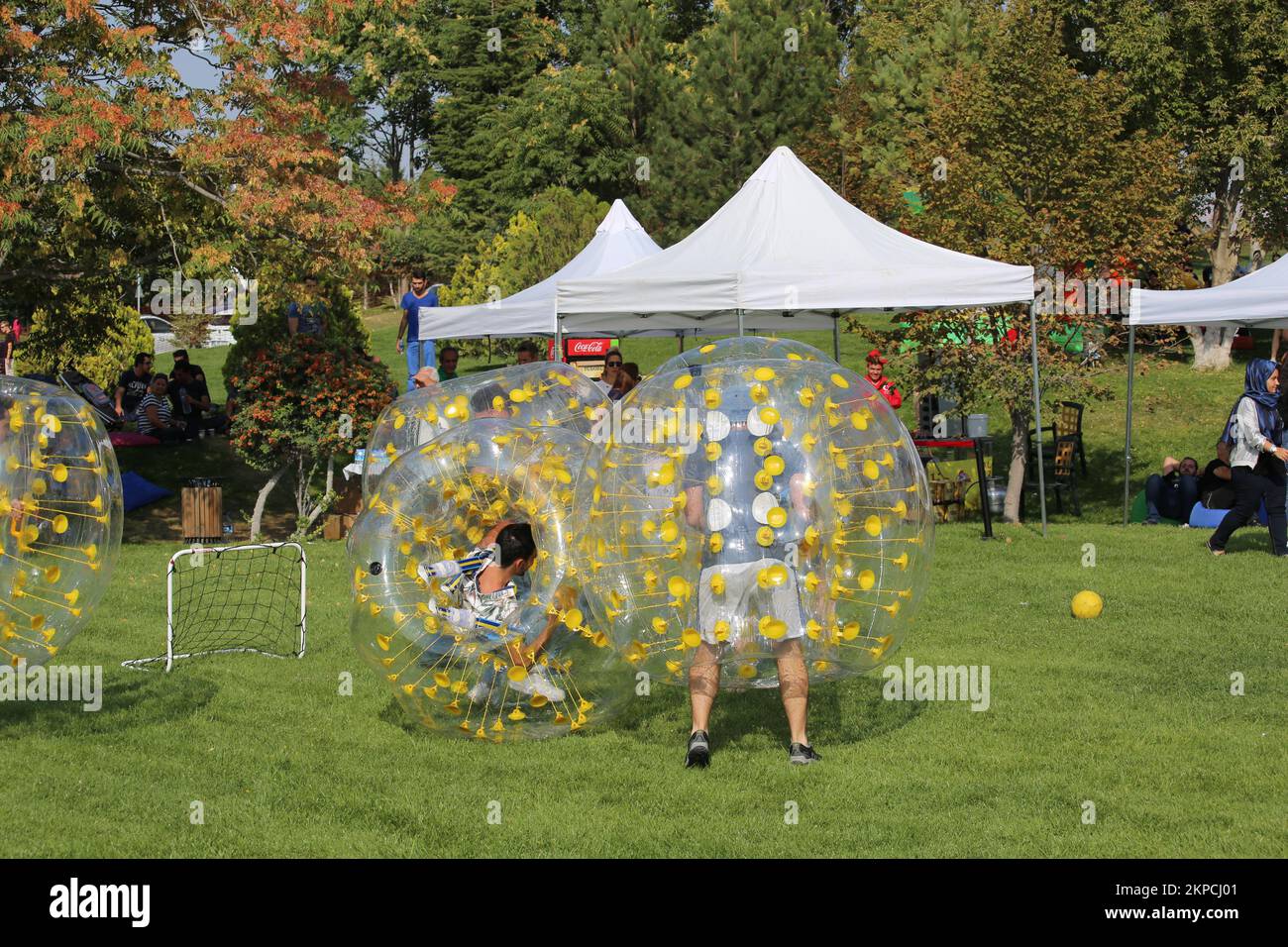 People playing bubble football at the festival area Stock Photo - Alamy