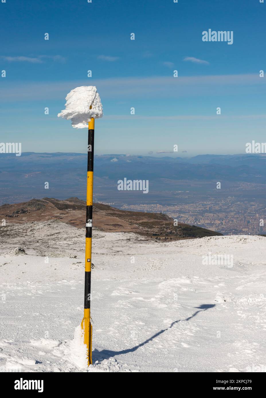 Snow covered frozen snow level pole marker in rime ice in Vitosha ...