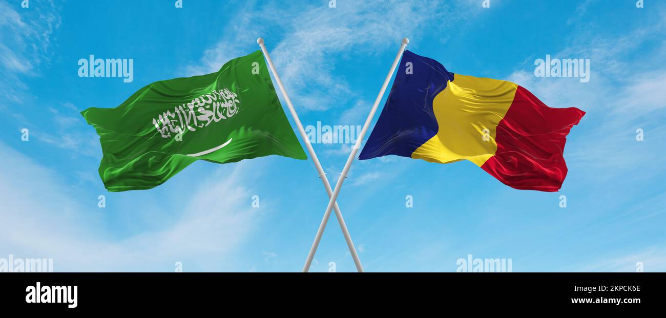two crossed flags romania and Saudi Arabia waving in wind at cloudy sky ...
