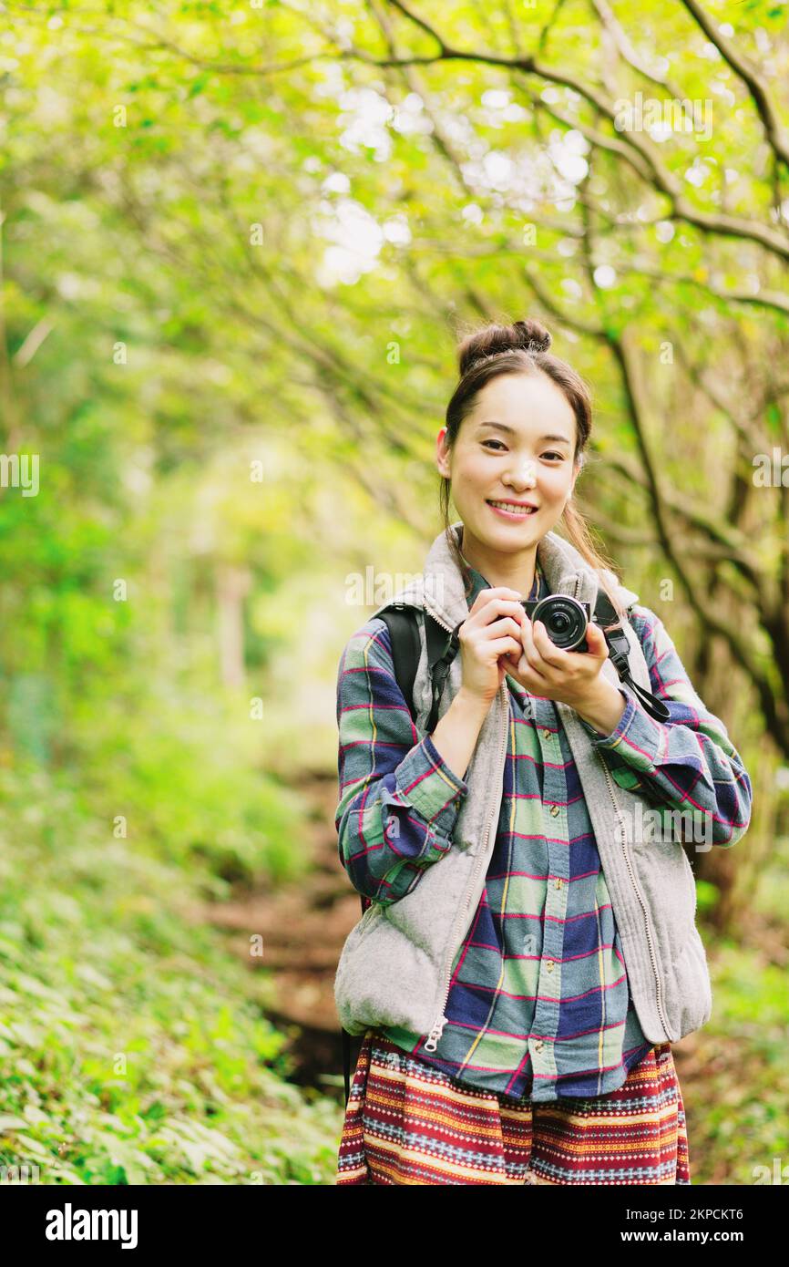 Japanese woman holding a camera Stock Photo - Alamy