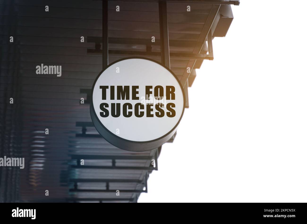 Business and Economics. There is a circular sign under the roof of the building that says - TIME ...