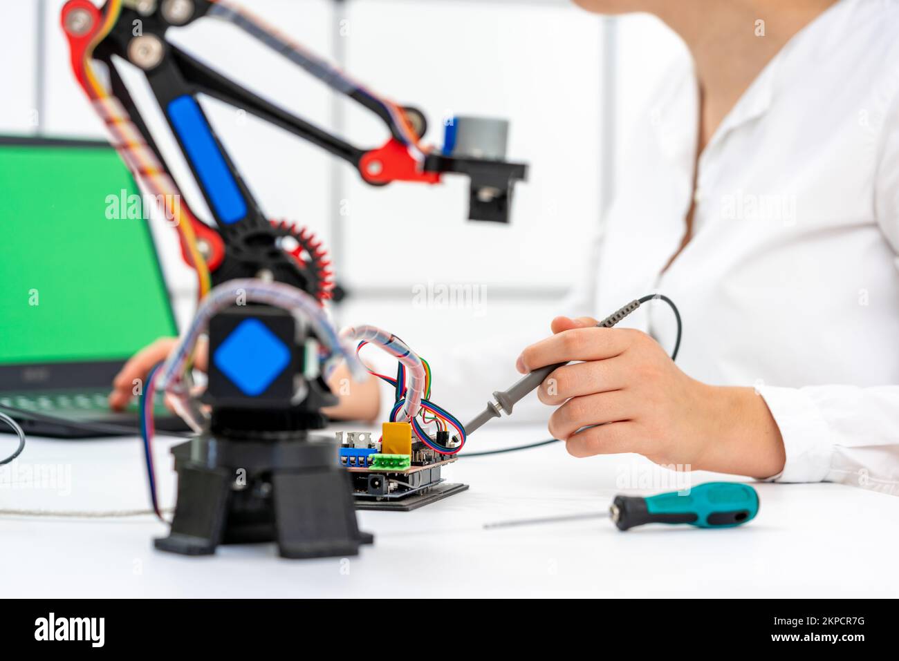 model of an industrial robot in a university lab women measure voltages ...