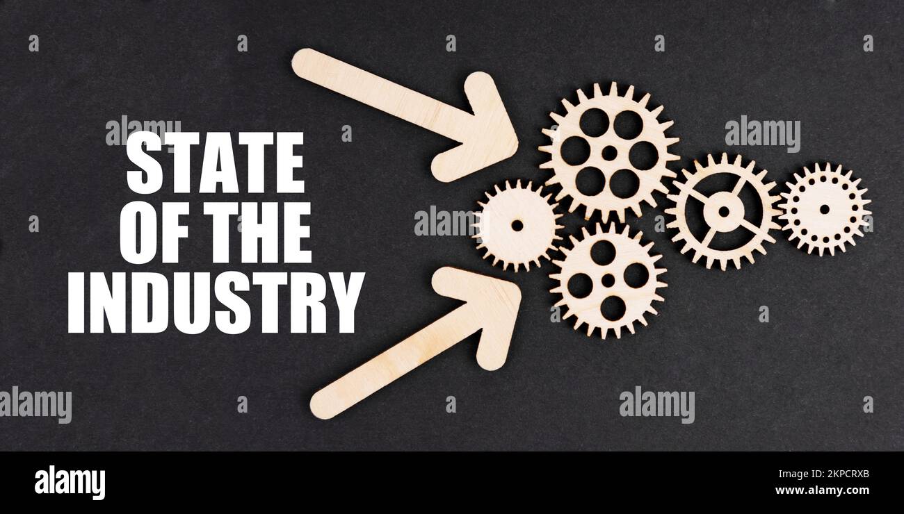 Industrial concept. On the black surface, arrows, gears and an ...