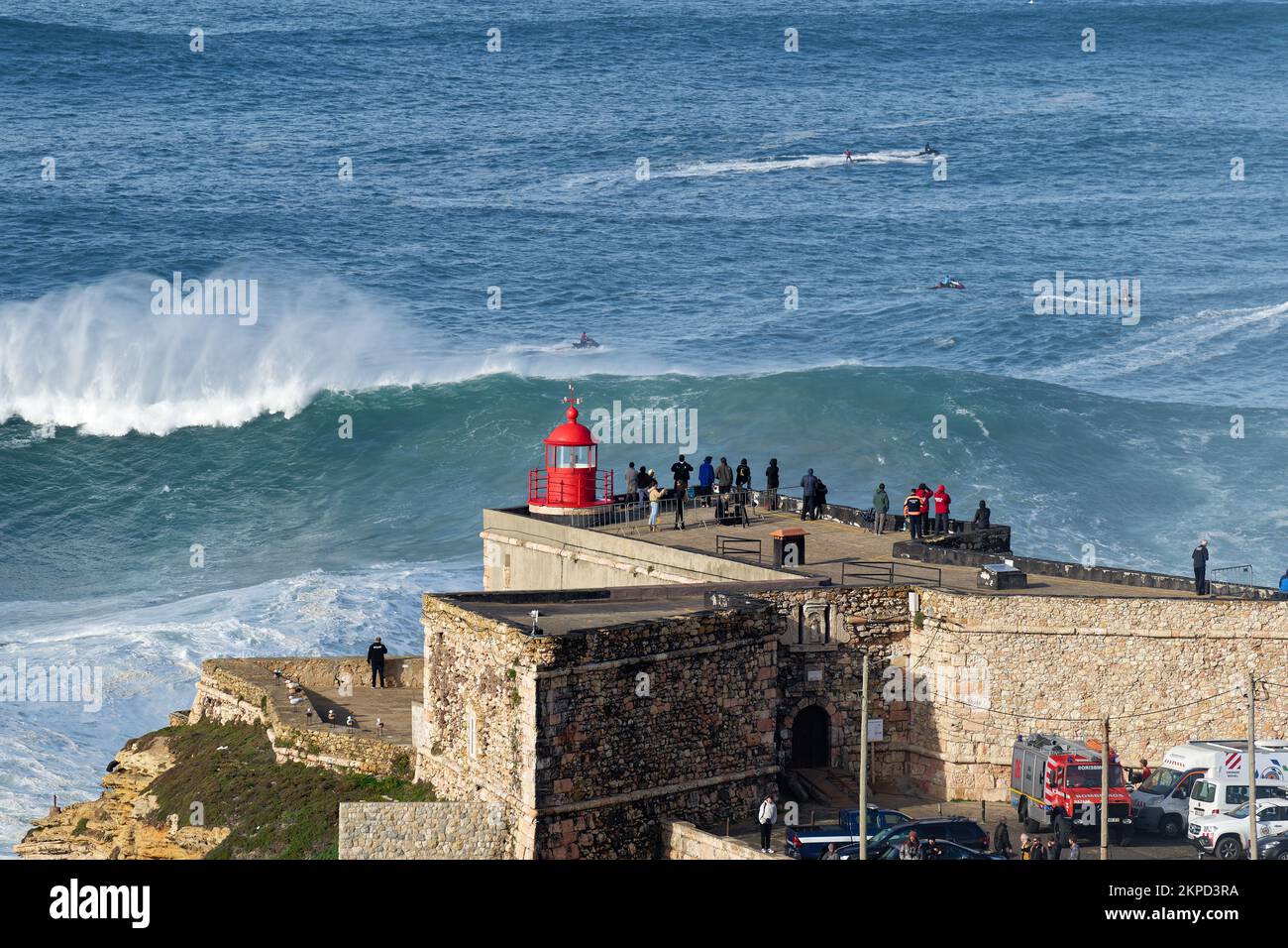 People watching the big giant waves crashing near the Fort of Nazare ...