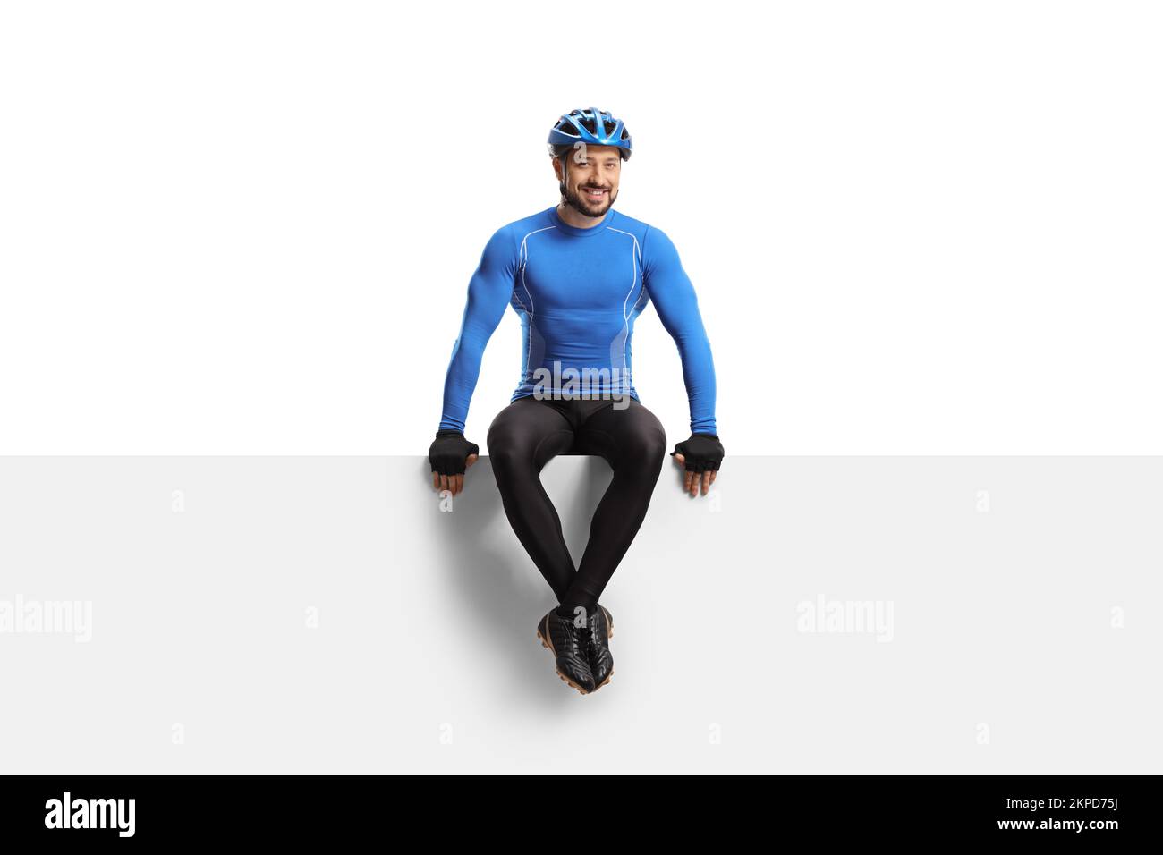 Fit male cyclist sitting on a blank panel isolated on white background ...