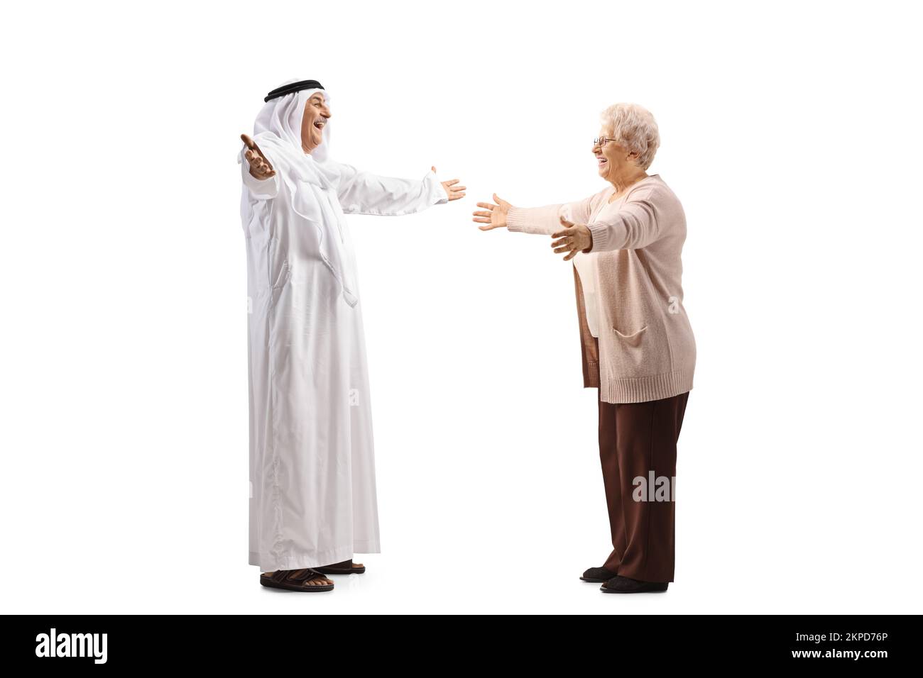 Full length profile shot of a mature arab man in a robe greeting an ...