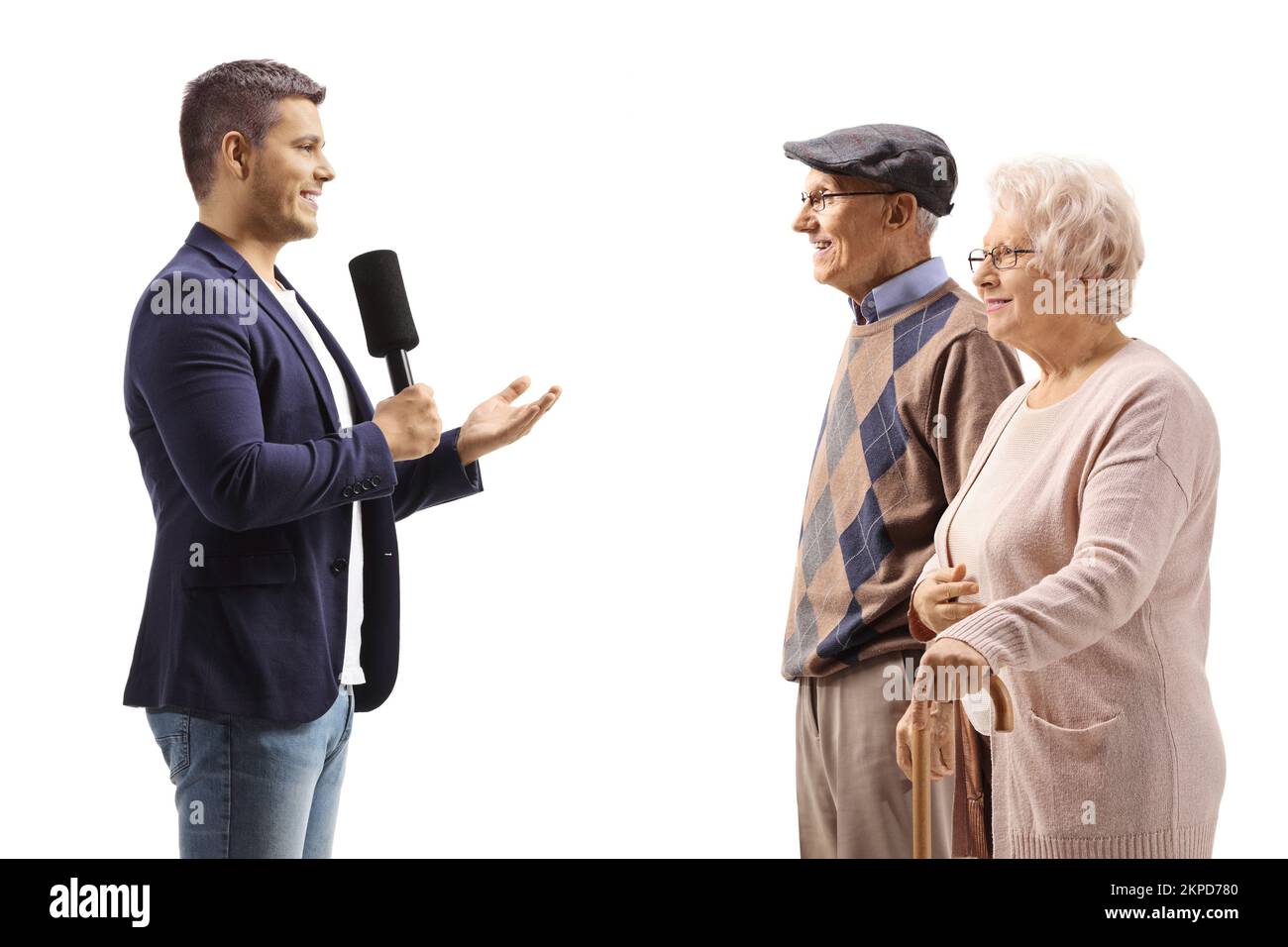 Male reporter interviewing an elderly couple isolated on white ...